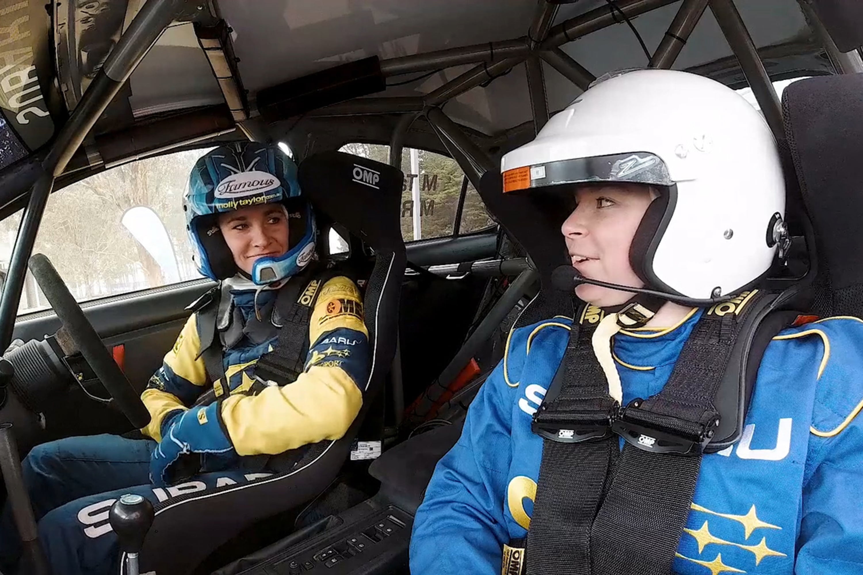 Molly Taylor takes a passenger in her works Subaru rally car